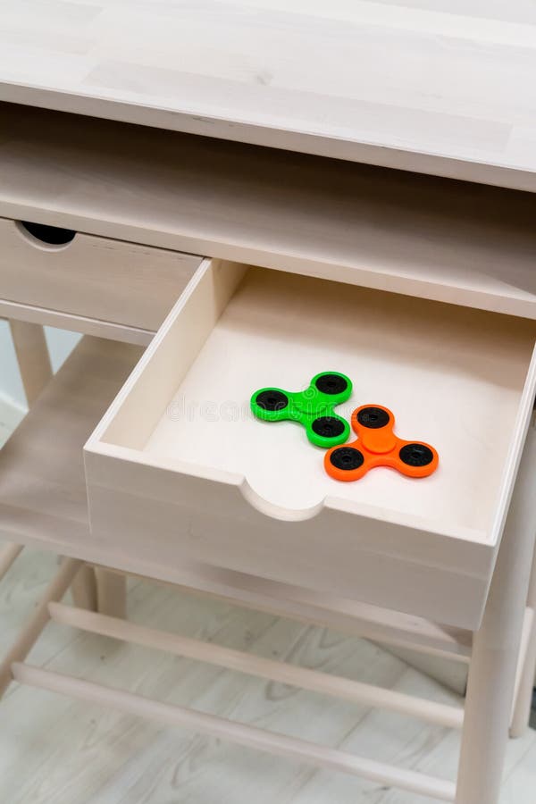 Spinners in open drawer stock photo. Image of distraction - 95009052
