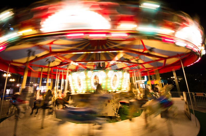 Spinning carousel at night stock image. Image of blur - 49396181