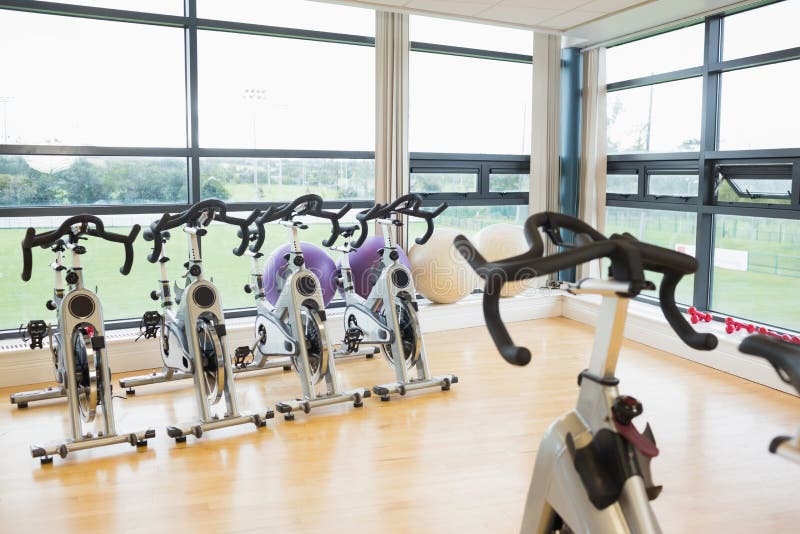 Spinning Exercise Bikes in Gym Room Stock Image - Image of clas, people ...