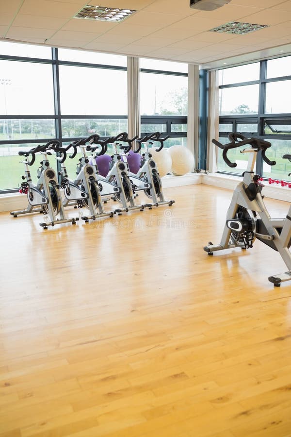 Spinning Exercise Bikes in Gym Room Stock Image - Image of heavy ...
