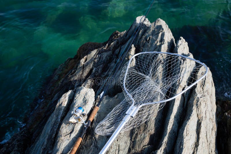 Spinning and Landing Net on a Rocky Shore Stock Image - Image of ...