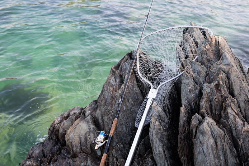 Spinning and Landing Net on a Rocky Shore Stock Image - Image of water ...