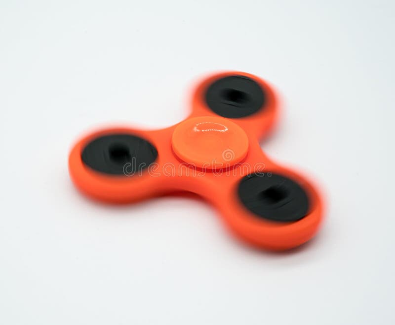 Spinning Orange Fidget Spinner Stock Image - Image of finger, black ...