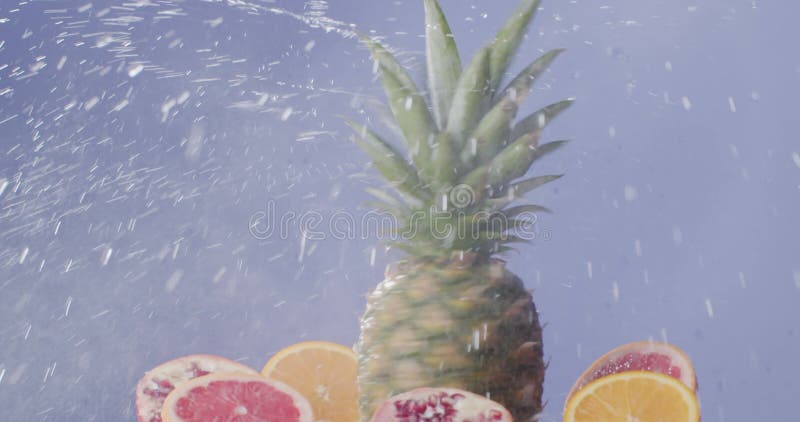 Spinning Pineapple Splashing Water with Oranges beside it Stock Footage ...