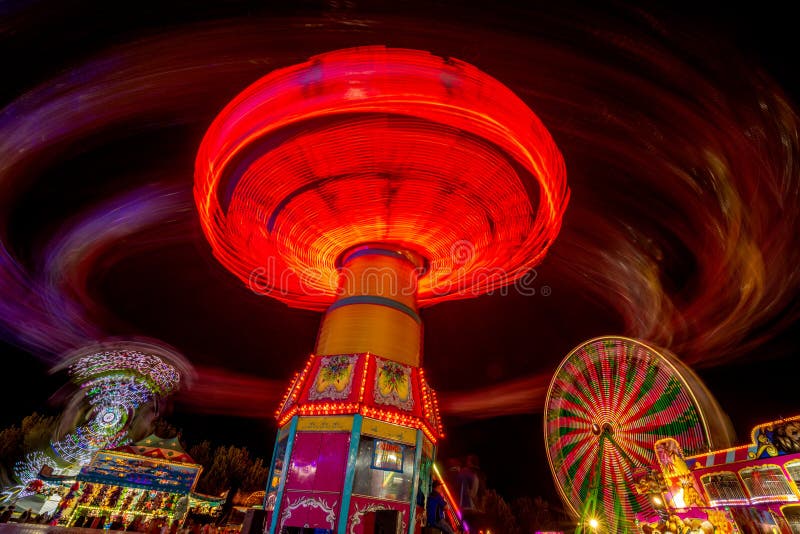 Spinning Ride at the Fair in the Late Night Illuminated with Lights ...