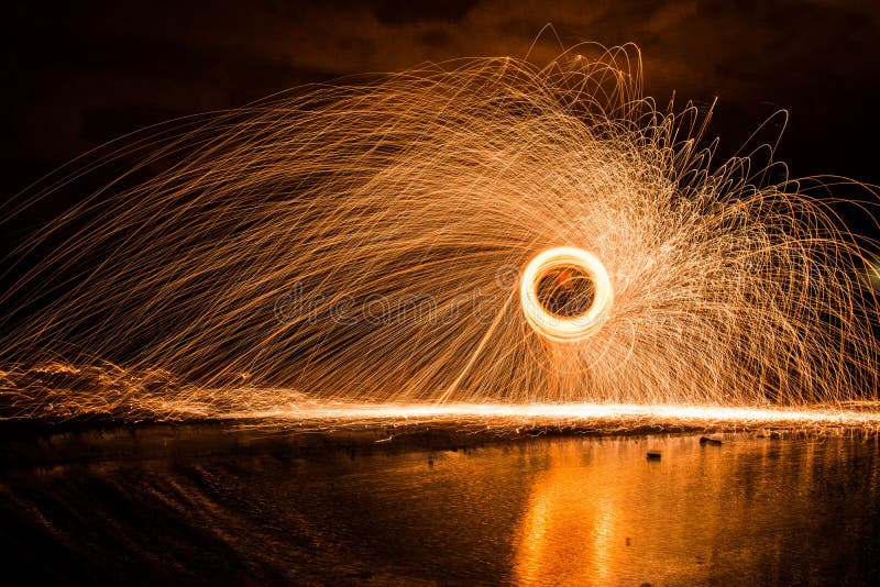 Spinning Steel Wool Sparks Reflecting Pool of Water Stock Image - Image ...