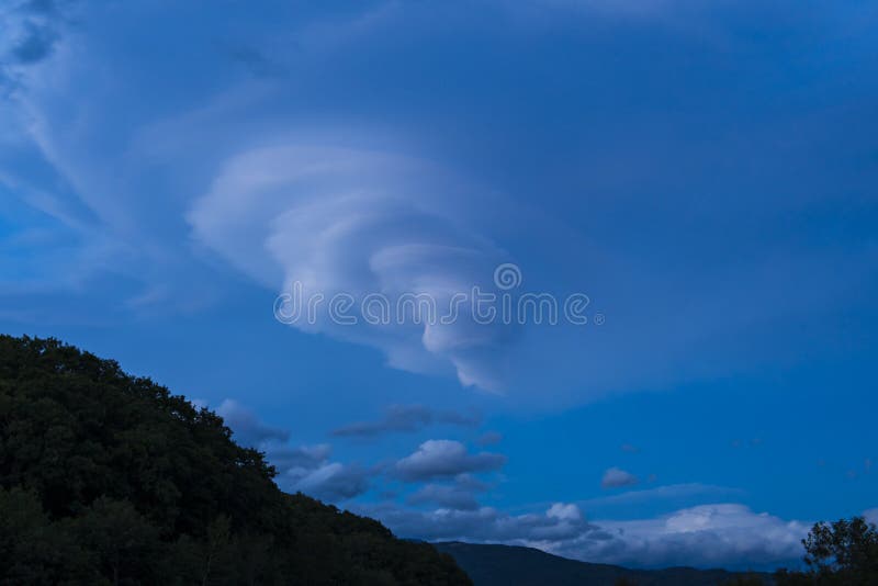 Spiral clouds in the sky stock image. Image of black - 254675291