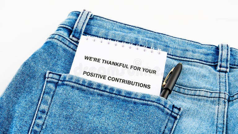 A Spiral Notebook Note is Visible in the Back Pocket of a Pair of Blue Denim Jeans, Emphasizing ...