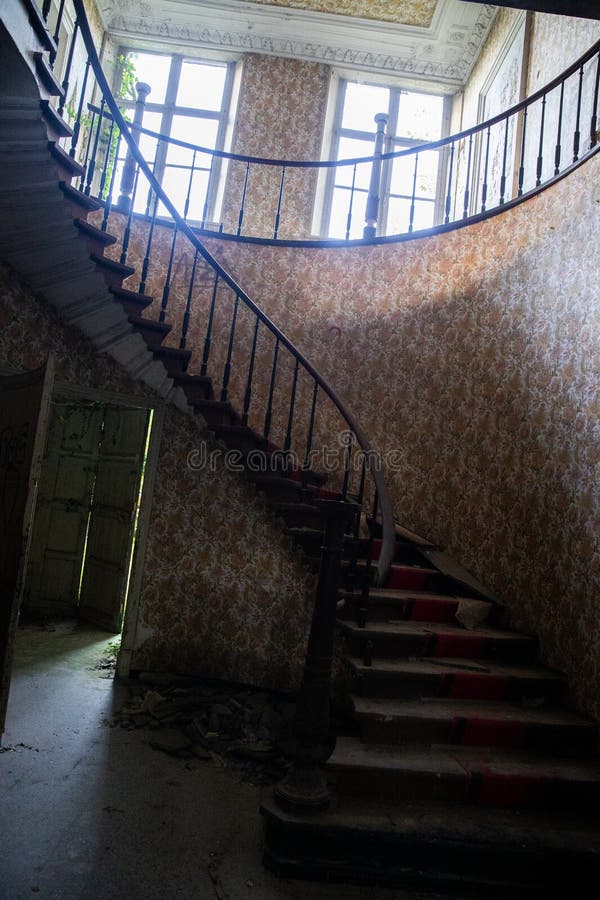 Spiral Staircase and Sunlit Interior in an Abandoned House Stock Image ...