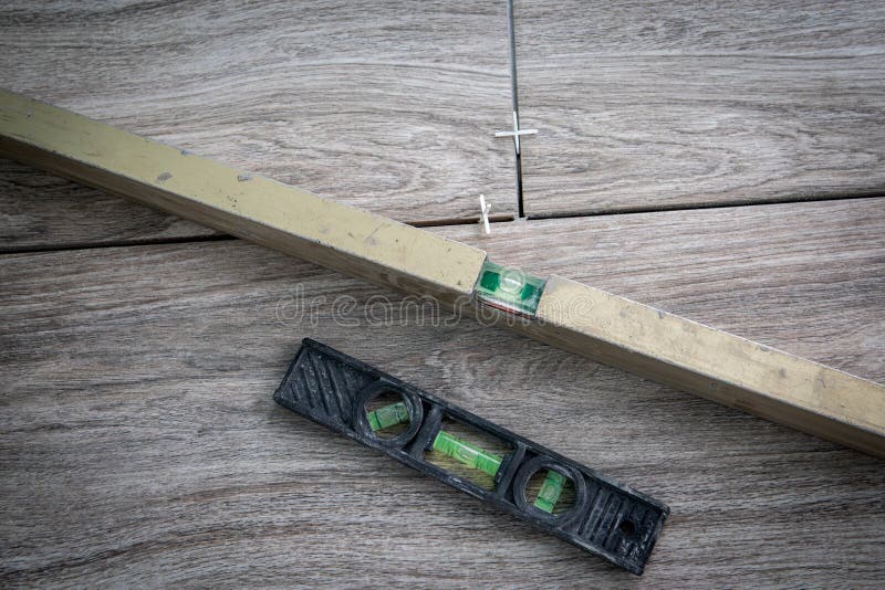 Spirit Level Tool or Bubble Levels at Construction Site. Laying Ceramic ...