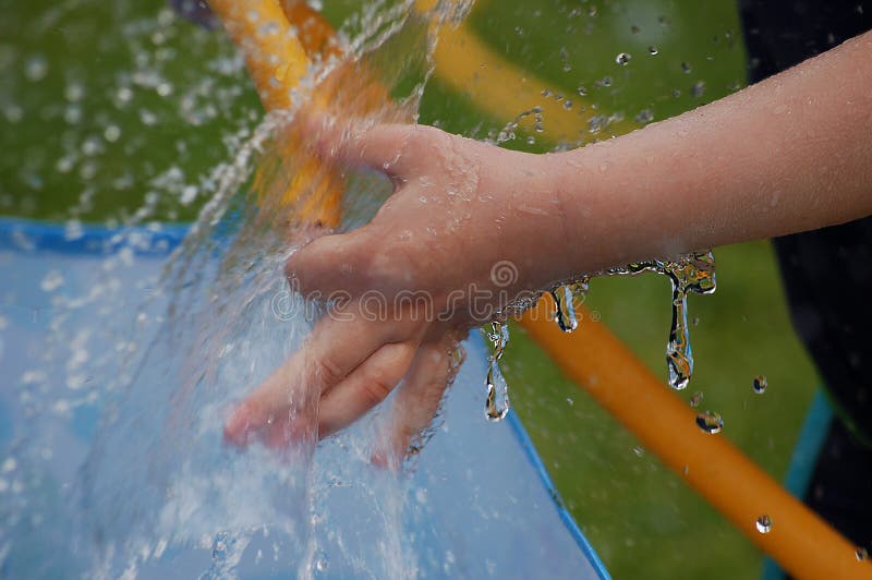 Splash stock photo. Image of splashing, pipe, hose, hand - 9765326