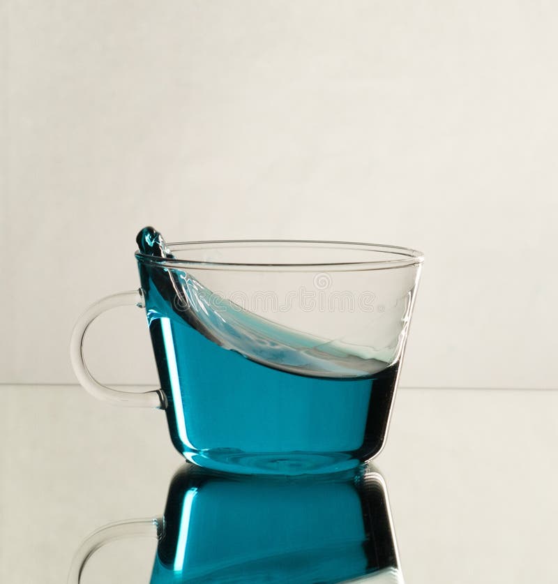 A Splash of Blue Alcohol in a Martini Glass Stock Photo - Image of ...