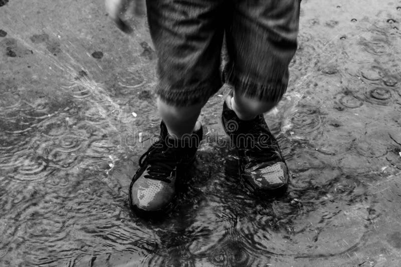 Splash from a Child Jumping in a Rain Puddle Stock Photo - Image of ...
