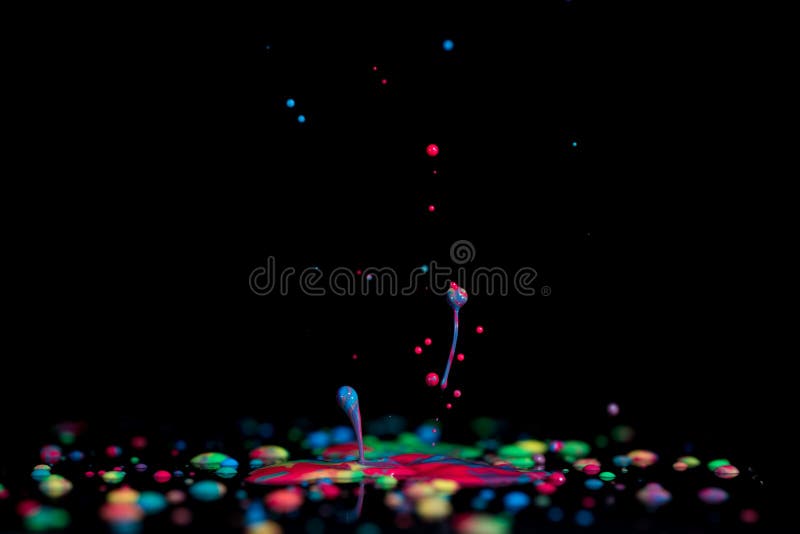 Splash of Colorful Liquid Paint on a Black Background Paint Splash on ...