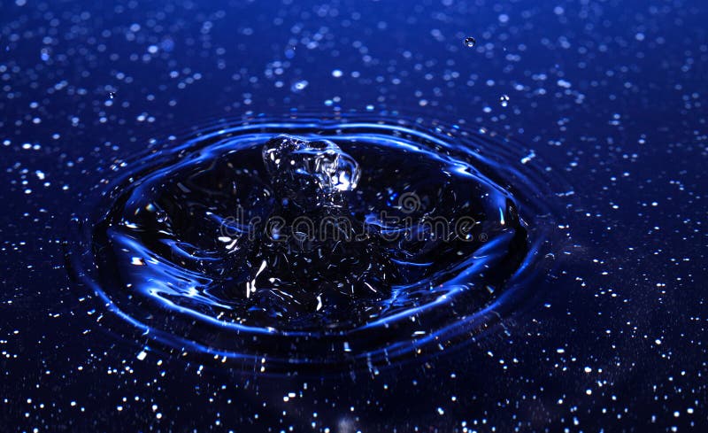 Splash - a Drop Falling Onto the Water Surface in Macro Shot Stock ...