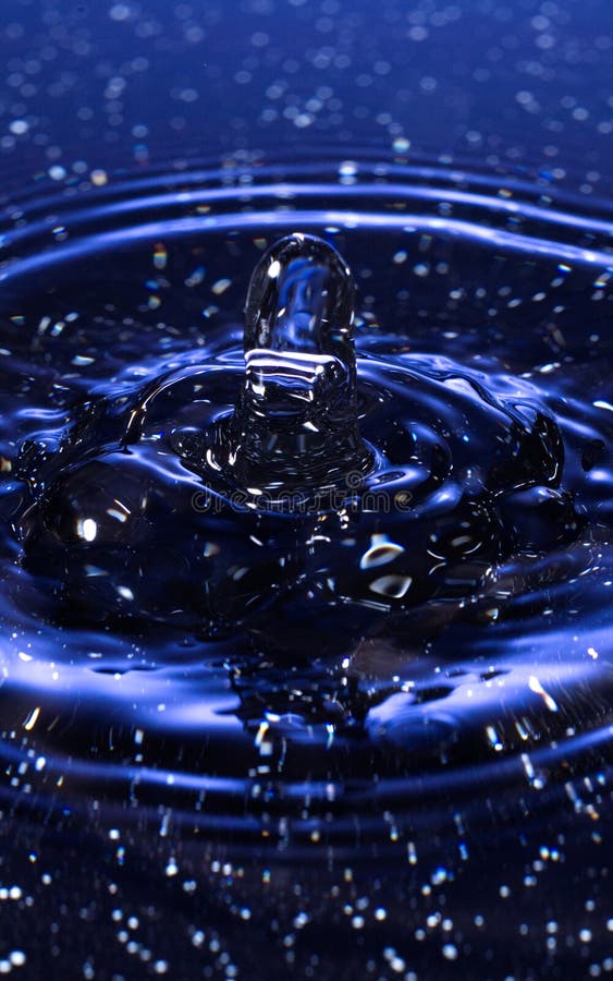 Splash - a Drop Falling Onto the Water Surface in Macro Shot Stock ...