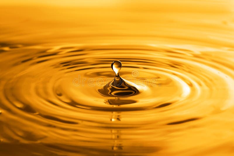 Splash of Golden Oily Liquid with Drop As Background, Closeup Stock ...