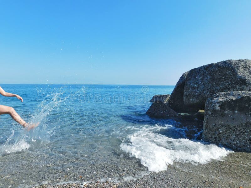 A Splash Scene on the Beach Stock Image - Image of sunny, hand: 73033893