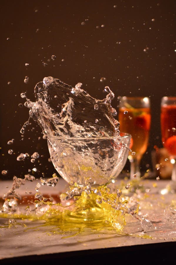 Splash Water in the Glass and Some of it Spills Around the Table Stock ...