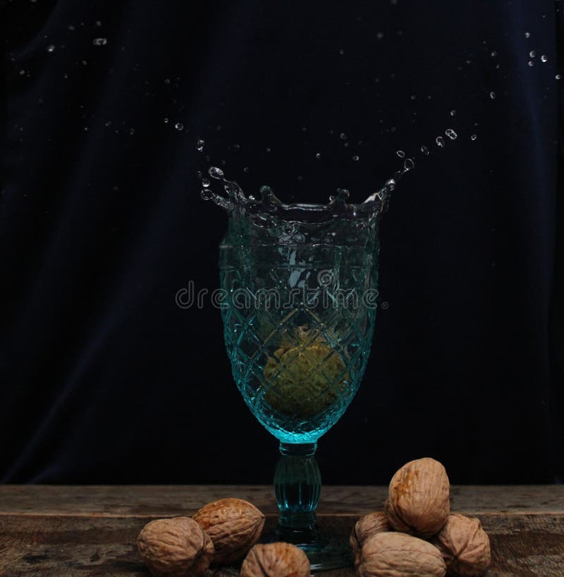Splash of Water in a Glass with a Walnut Stock Image - Image of drink ...