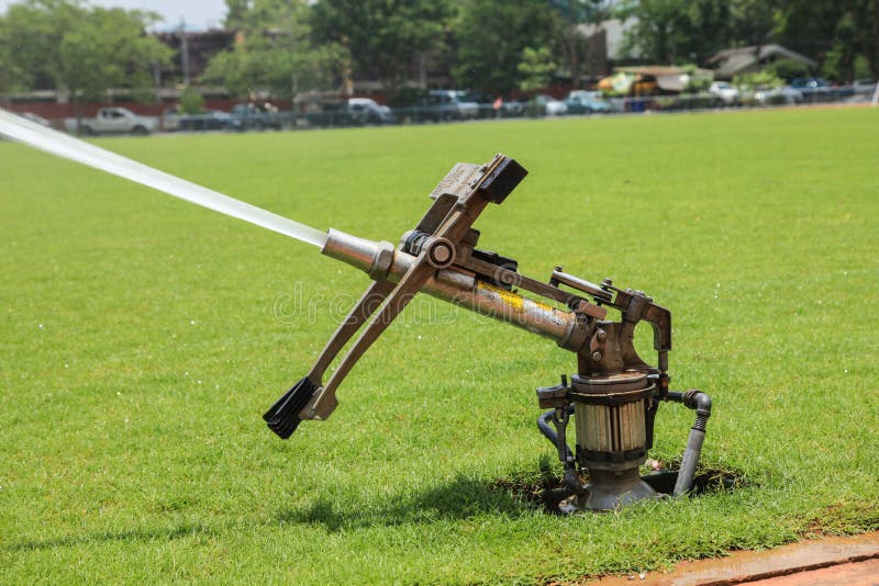 Sprinkler System Working on Fresh Green Grass on Football (soccer ...