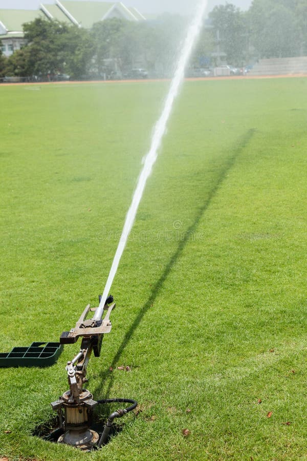 Splash Water To Football Field Stock Image - Image of football, water ...