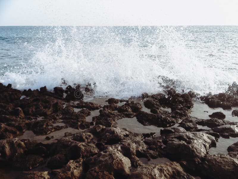 The Splash of Water when the Wave Breaks between the Rocks Stock Photo ...