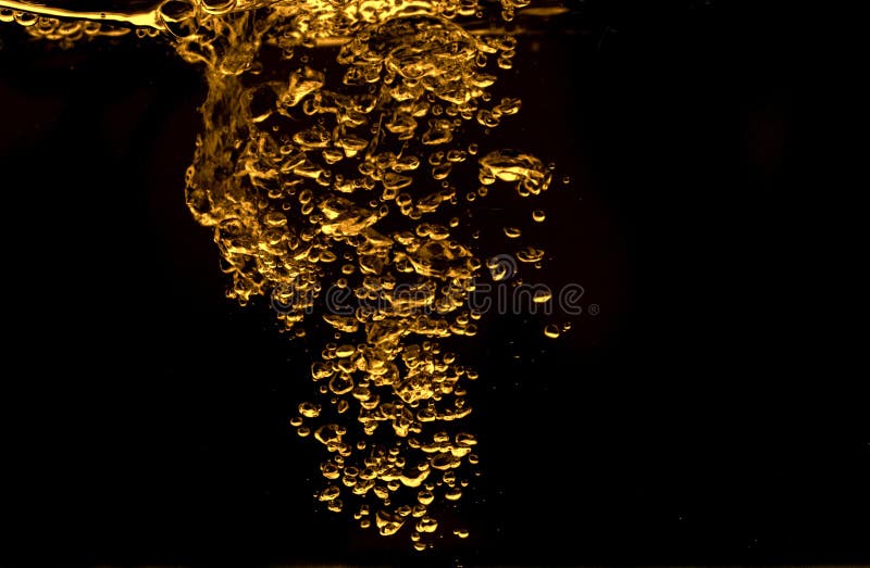Splash Water Yellow Gold with Bubbles of Air on Black Background Stock ...