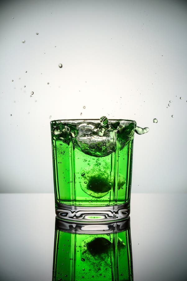 The Splashes from the Falling Ice in Green Cocktail Stock Photo - Image ...