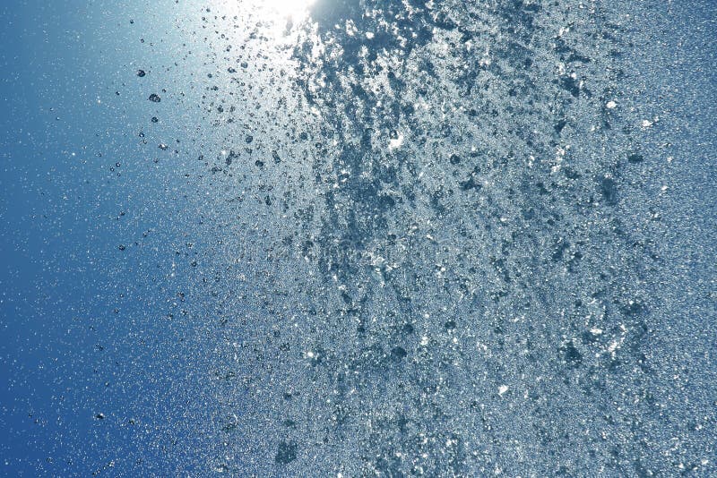 Splashes of Flying Water from the Fountain Against the Blue Sky Stock ...