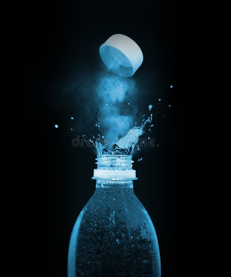 Splashes of Mineral Water Spill Out of the Bottle in the Dark Stock ...
