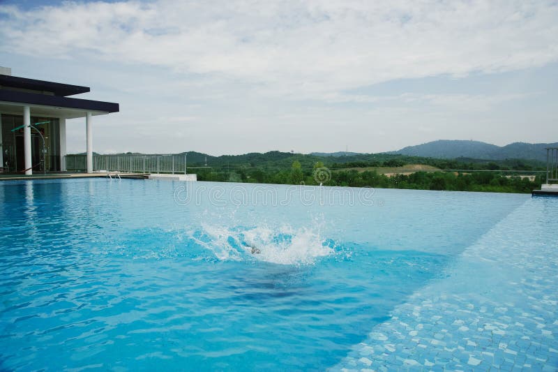 Splashes of Water from Diving in the Pool in a Luxury Resort Hotel ...