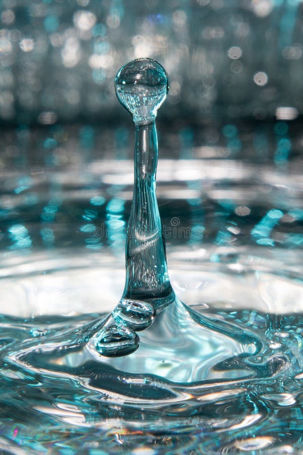 Splashes of Water from a Drop Falling into a Container in Color Stock ...