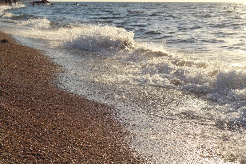Splashes of Waves at Sunset on a Sandy Beach Shell Stock Image - Image ...