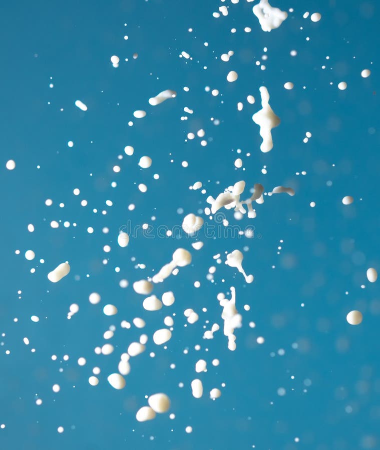 Splashes of White Milk Isolated on a Blue Background. Stock Image ...