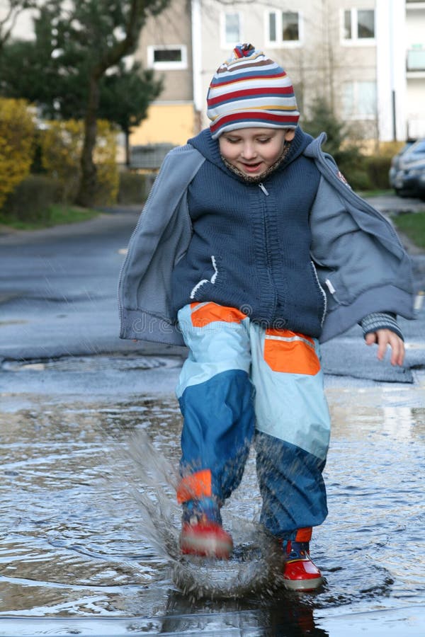 Splashing in a mud puddle stock photo. Image of funny - 6137118