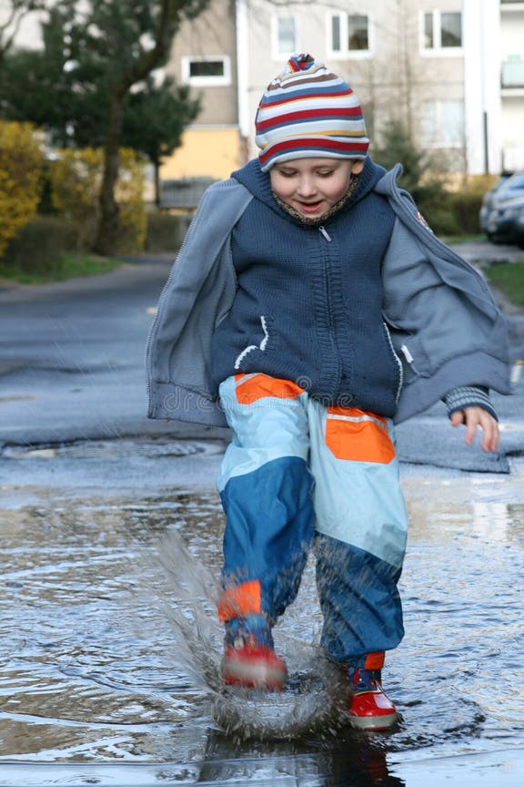 Splashing in a mud puddle stock photo. Image of funny - 6137118