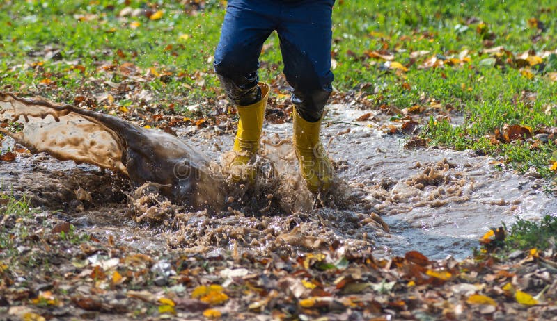 Splashing in puddle stock photo. Image of boot, close - 57677198