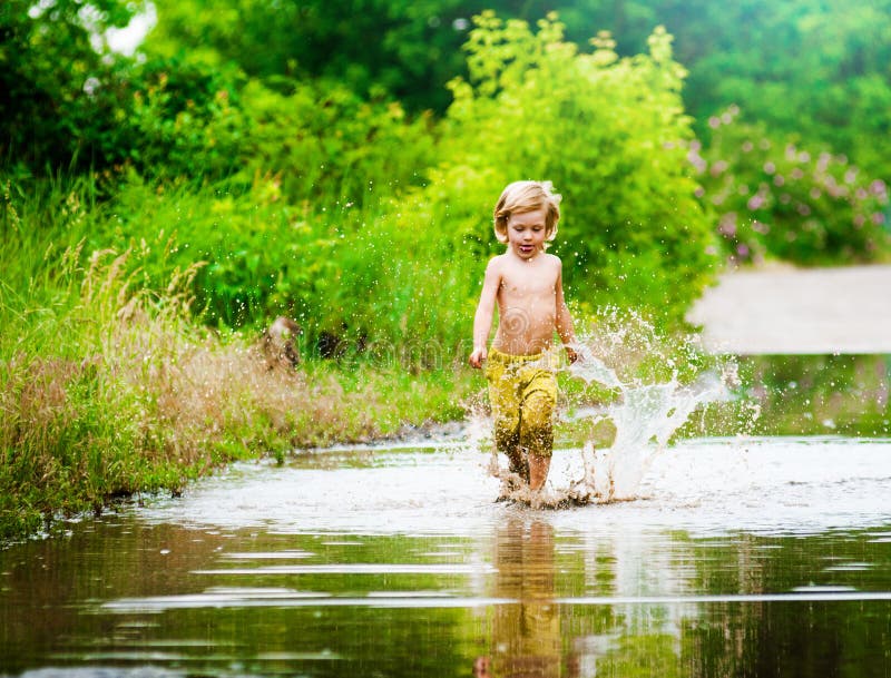 Splashing in a puddle stock image. Image of smiling, happy - 41345937