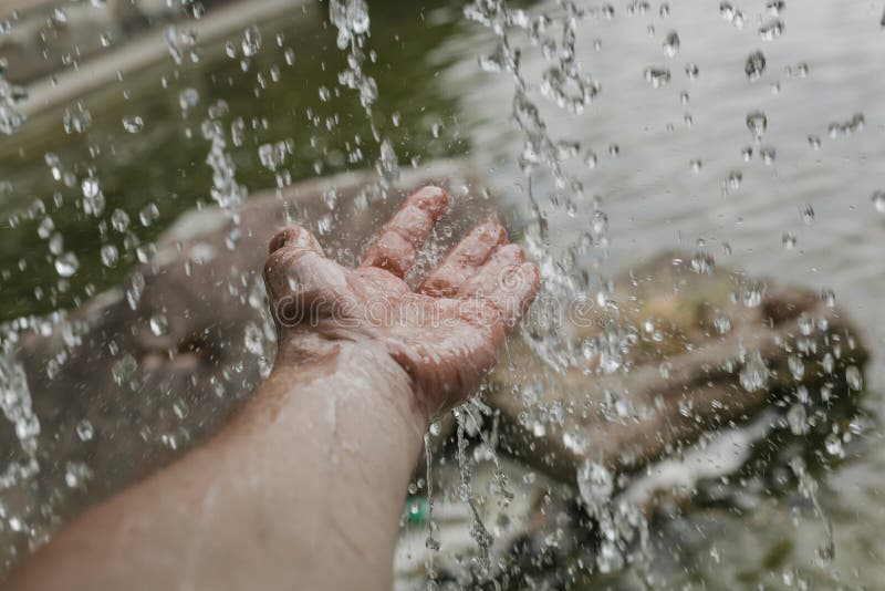 Splashing Water Falling on a Man`s Hand from a Waterfall Stock Image ...