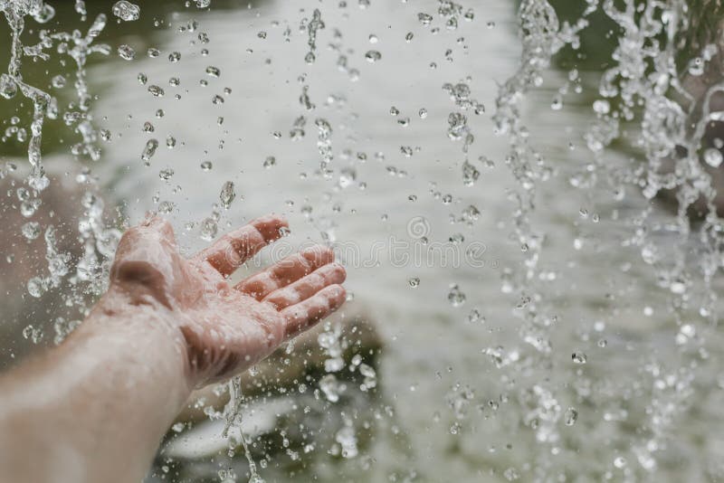 Splashing Water Falling on a Man`s Hand from a Waterfall Stock Image ...