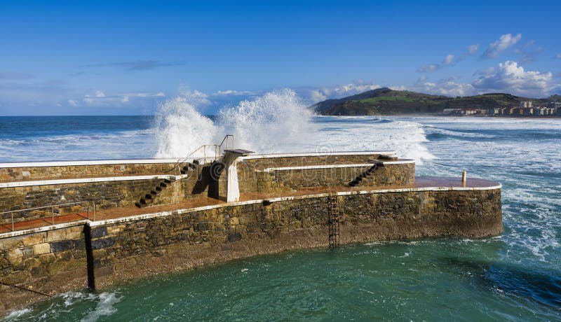 Splashing wave at jetty stock image. Image of country - 173591203