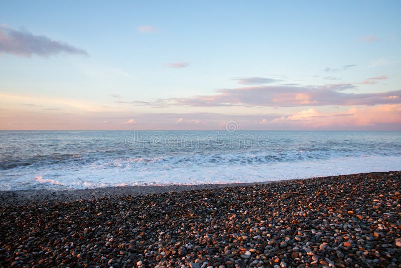 Splashing Waves on the Pebbly Beach on the Sunset Stock Image - Image ...