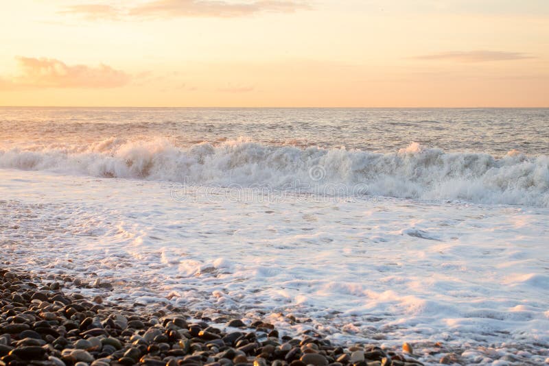 Splashing Waves on the Pebbly Beach on the Sunset Stock Photo - Image ...