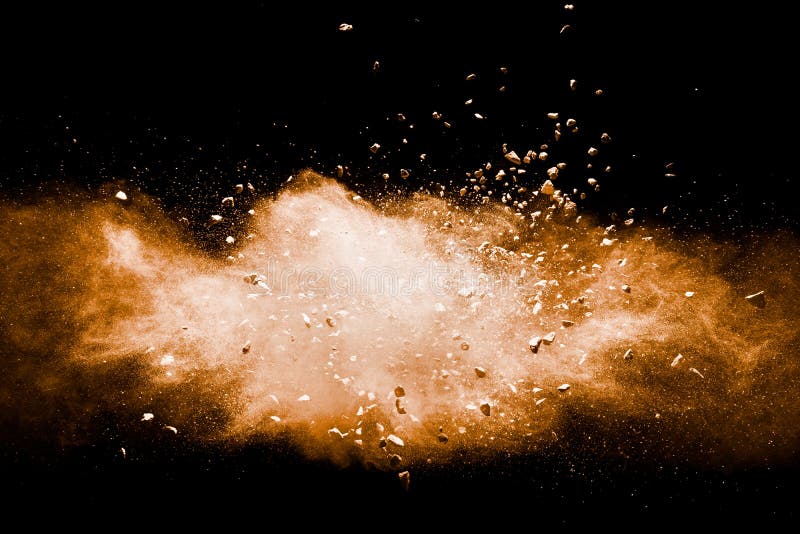 Split Debris of Stone Exploding with Orange Powder Against Black ...