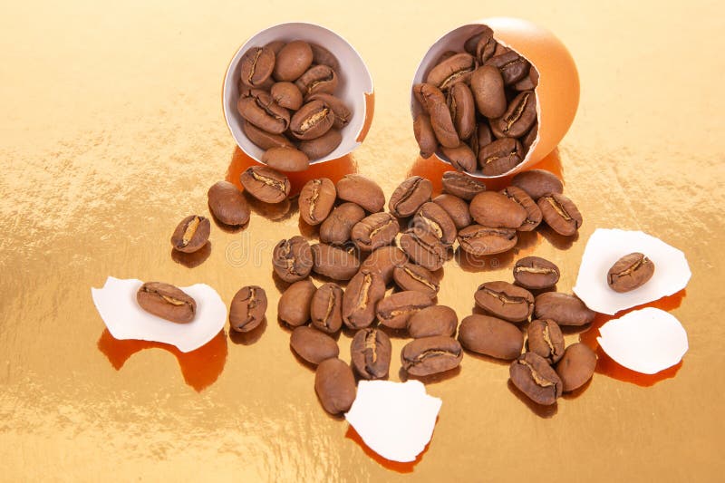 A Split Egg Reveals Coffee Beans Inside, Scattered on a Reflective ...