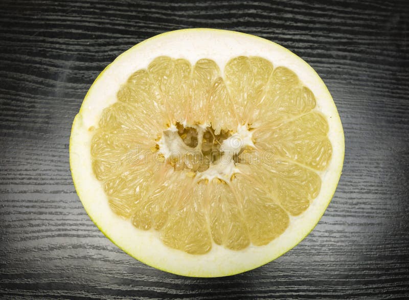Split Ripe Fruit Pomelo on the Table. Stock Photo - Image of dark ...