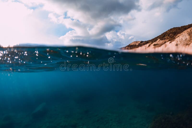 Split Shot with Coastline and Underwater Scene with Sun Rays and ...