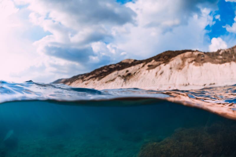 Split Shot with Coastline and Underwater Scene with Sun Rays and ...