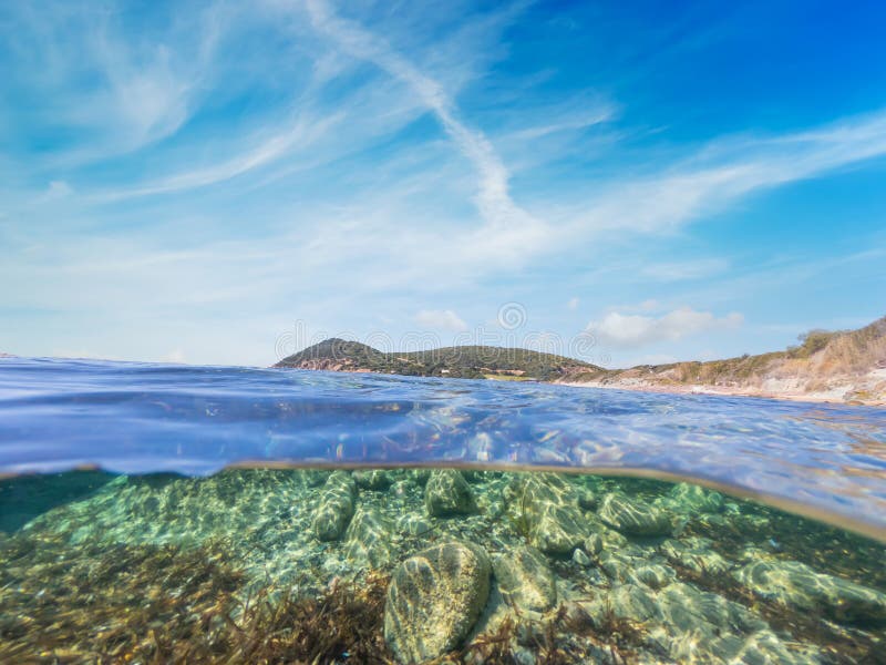 Split Underwater View of Rocks and Sand in La Speranza Beach Stock ...
